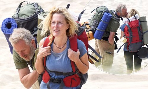 Gillian Anderson and Jason Isaacs look exhausted as they share a passionate kiss while filming ...