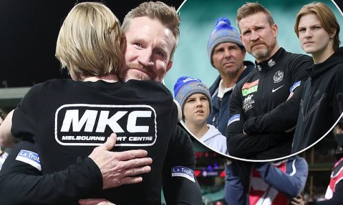 Nathan Buckley celebrates with his sons Jett and Ayce after seeing the ...
