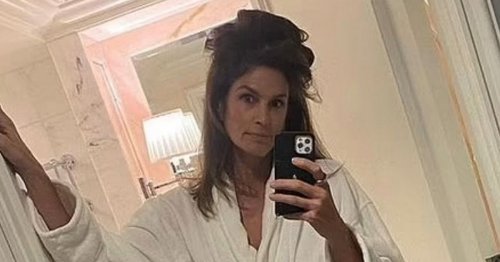 Cindy Crawford shows off endless legs under white bathrobe for racy ...