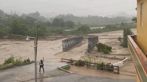 Moment bridge is swept away by floodwater as Hurricane Fiona batters ...